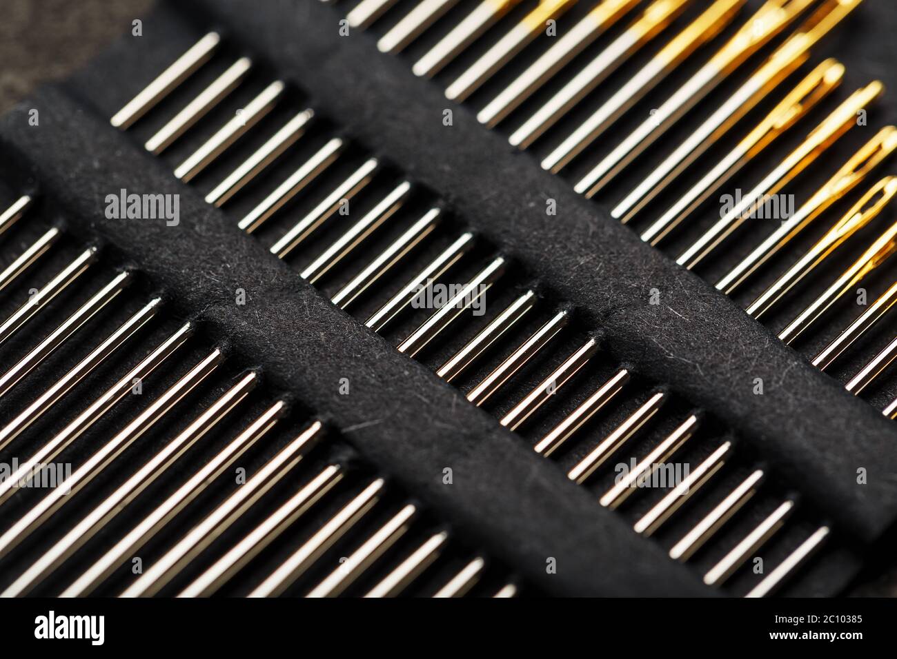 Set of Gold needles on a black background in a row Stock Photo - Alamy