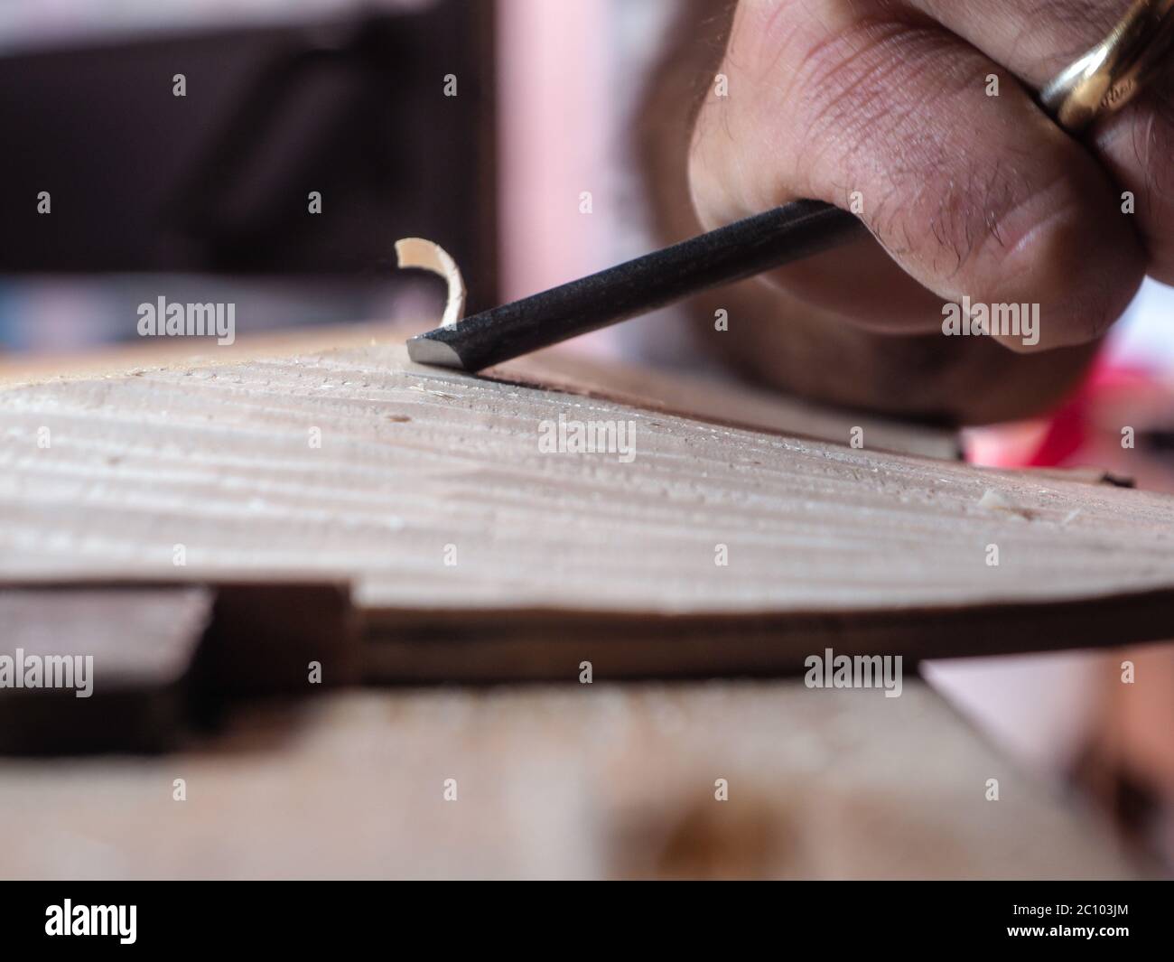 Professional luthier violinmaker artisan working on making a handmade ...