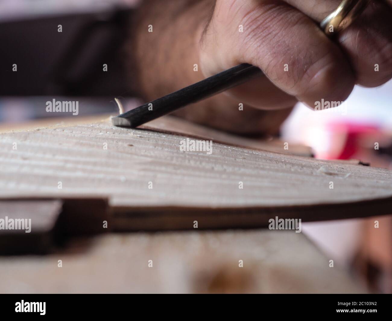 Professional luthier violinmaker artisan working on making a handmade ...