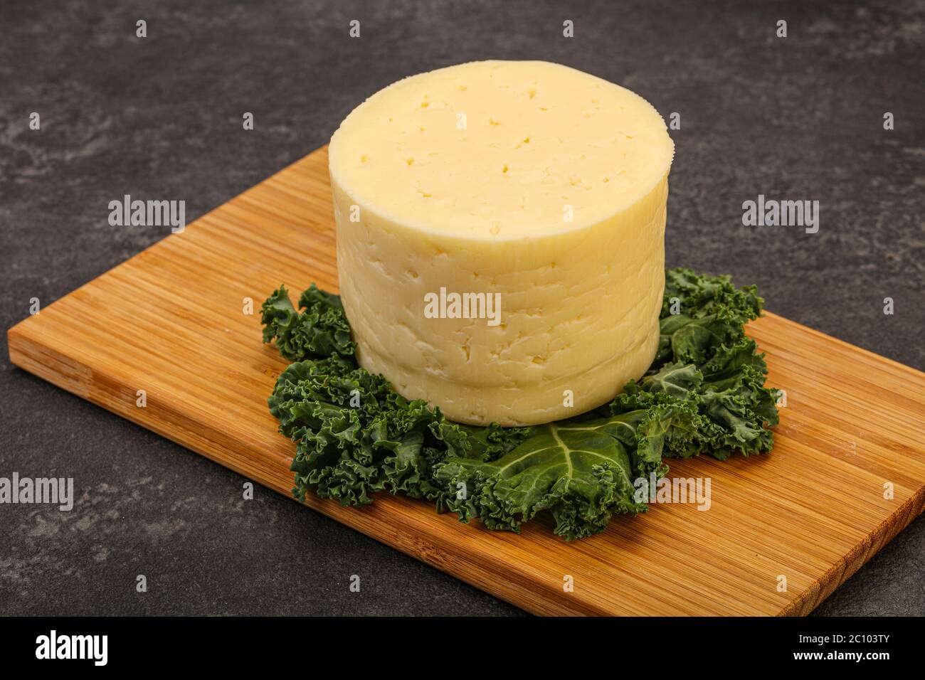 Yellow round dairy soft cheese piece Stock Photo - Alamy