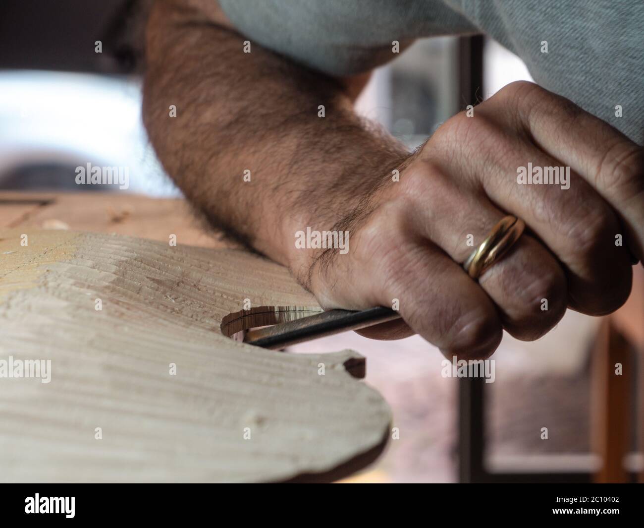 Professional luthier violinmaker artisan working on making a handmade ...