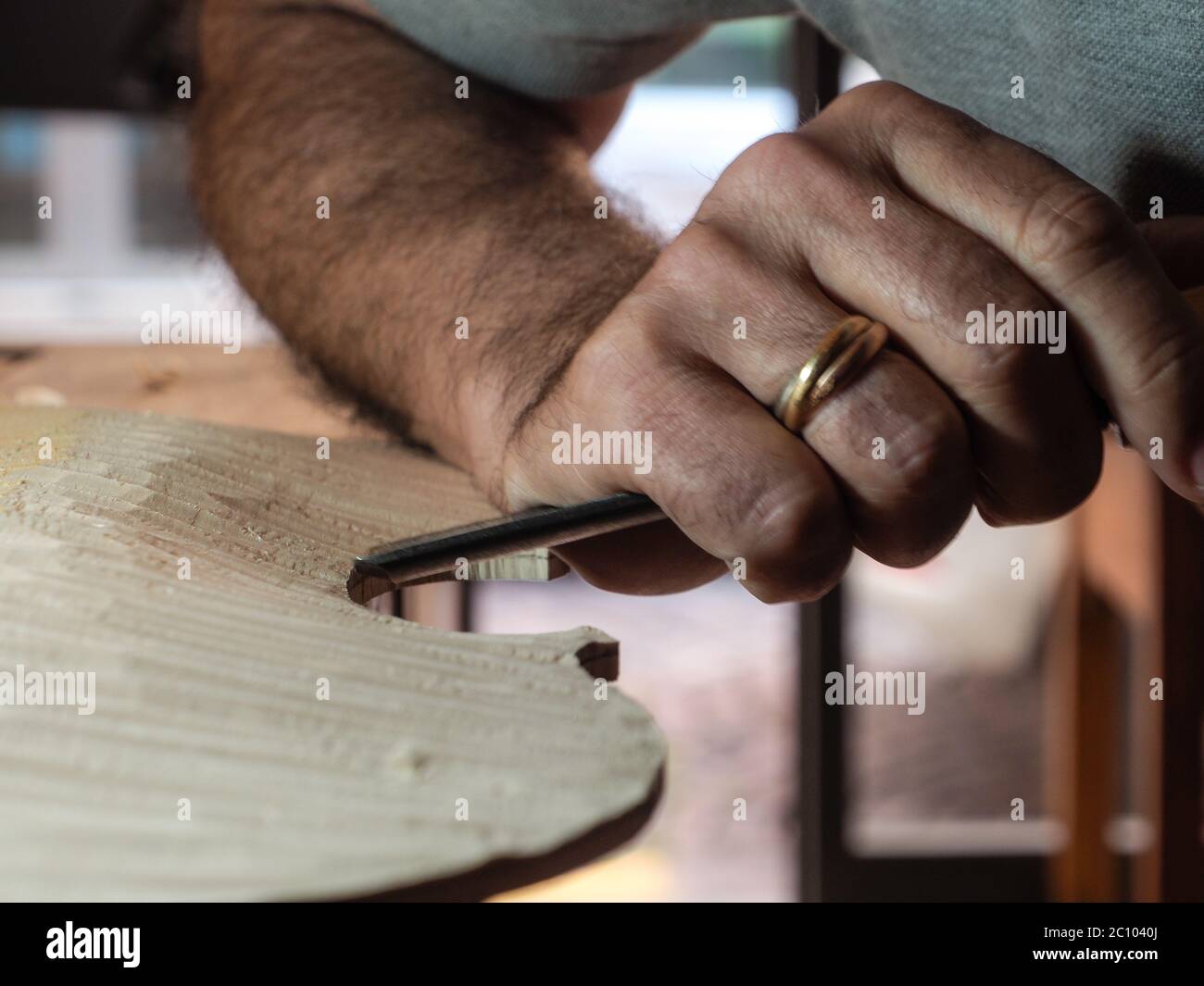 Professional luthier violinmaker artisan working on making a handmade ...