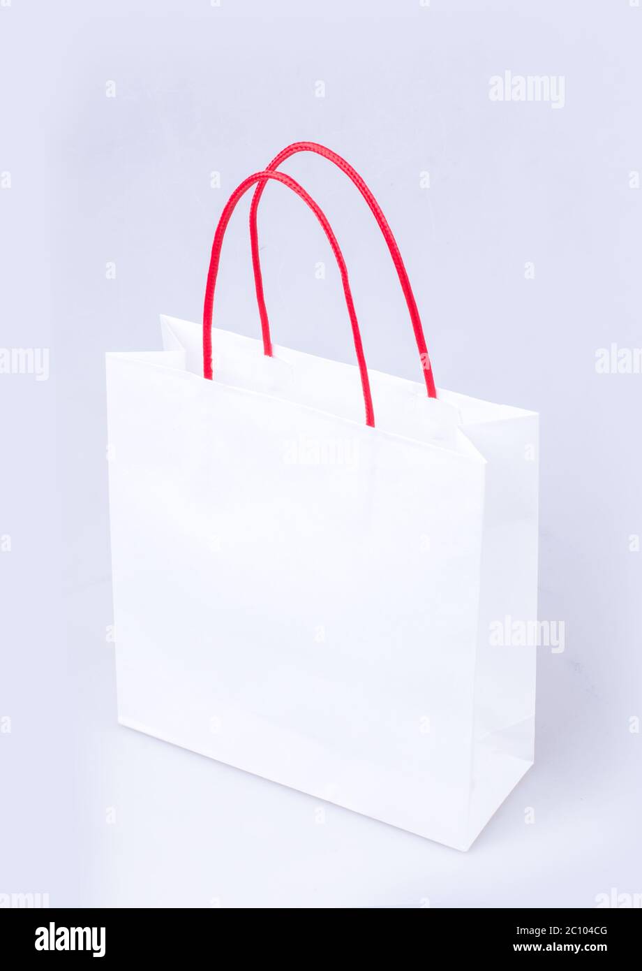 elegant white paper shopping bag with red handle Stock Photo - Alamy