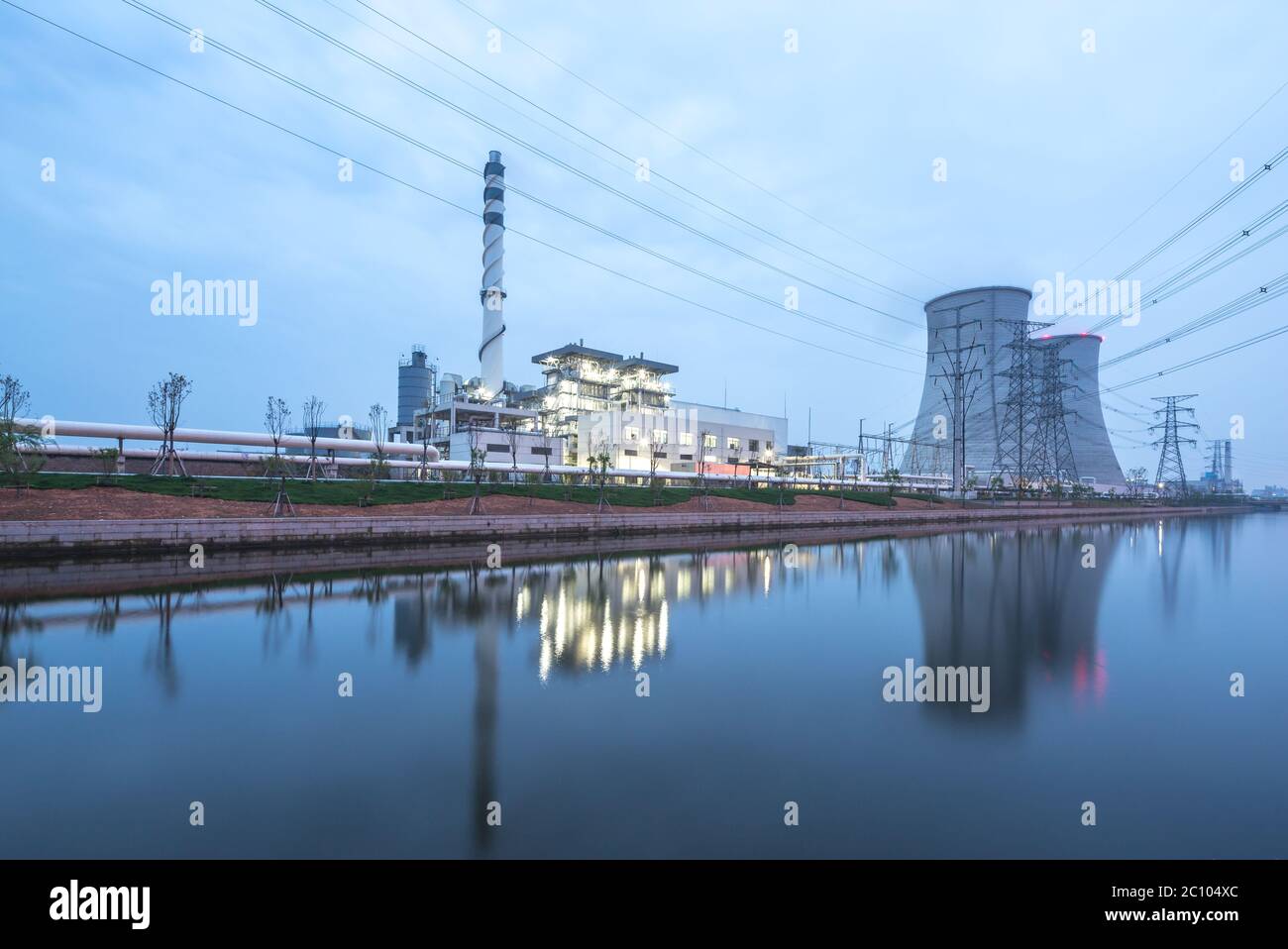modern power station near river at twilight Stock Photo - Alamy