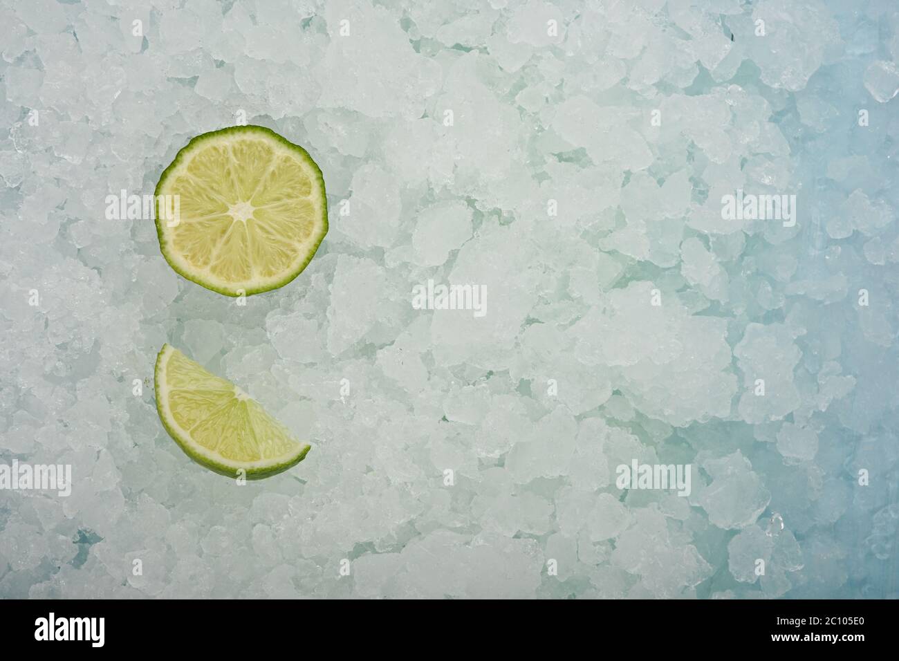 Close up fresh juicy green lime cut half and wedge slice over ...