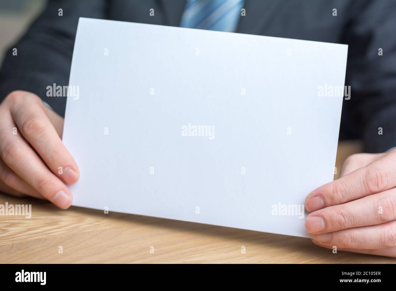 Businessman holding blank paper hi-res stock photography and images - Alamy