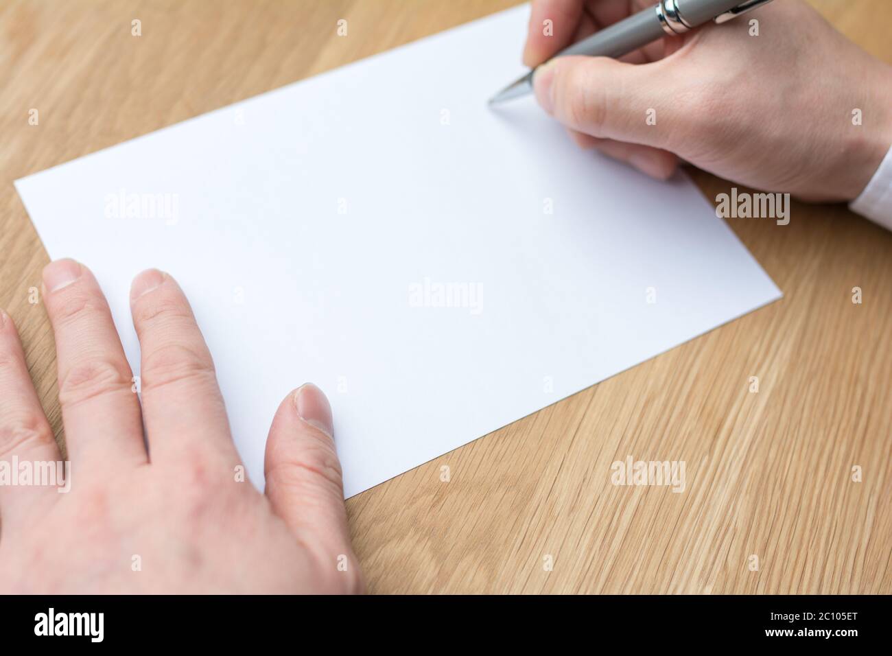 businessman writing on white paper Stock Photo - Alamy