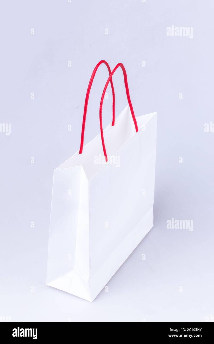 elegant white paper shopping bag with red handle Stock Photo - Alamy