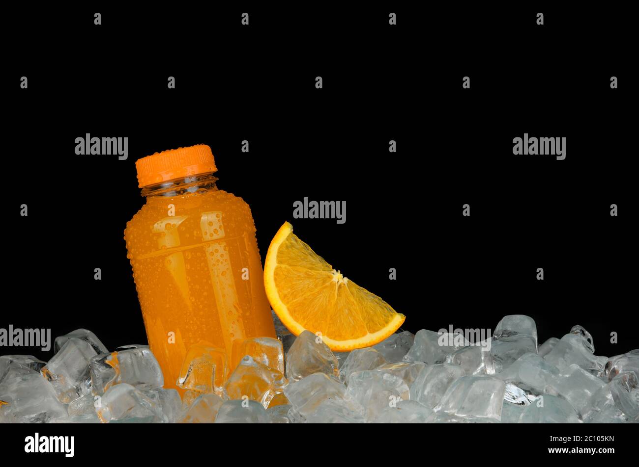 Close up one plastic PET bottle full of fresh orange juice and cut ...
