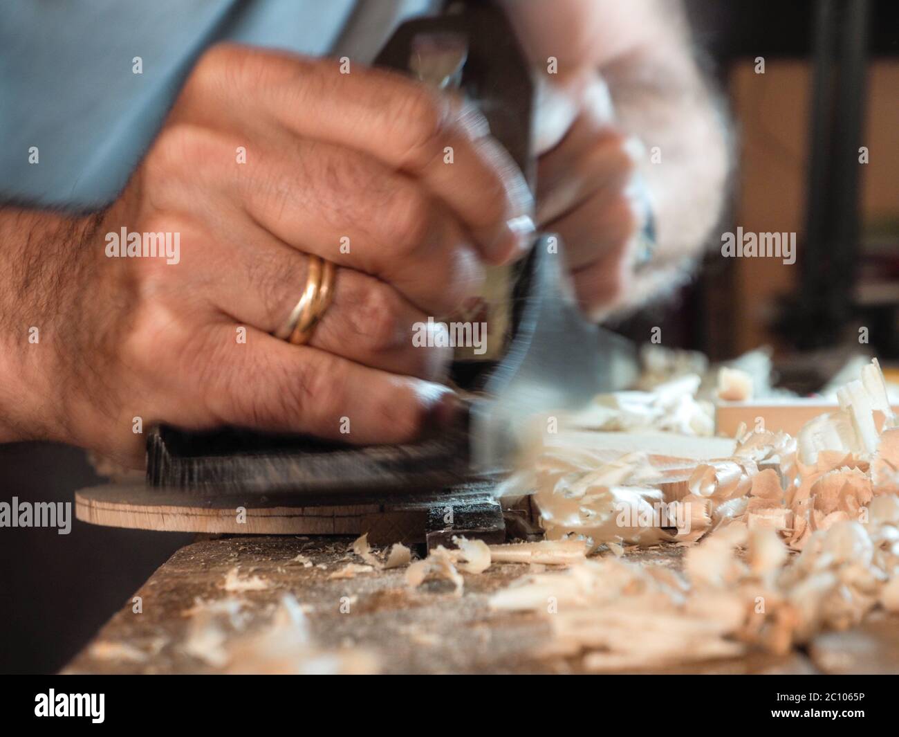 Professional luthier violinmaker artisan working on making a handmade ...