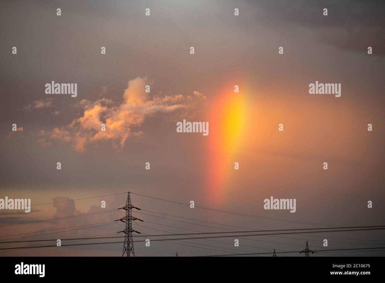 Rainbow and dramatic clouds in the sunset Stock Photo - Alamy