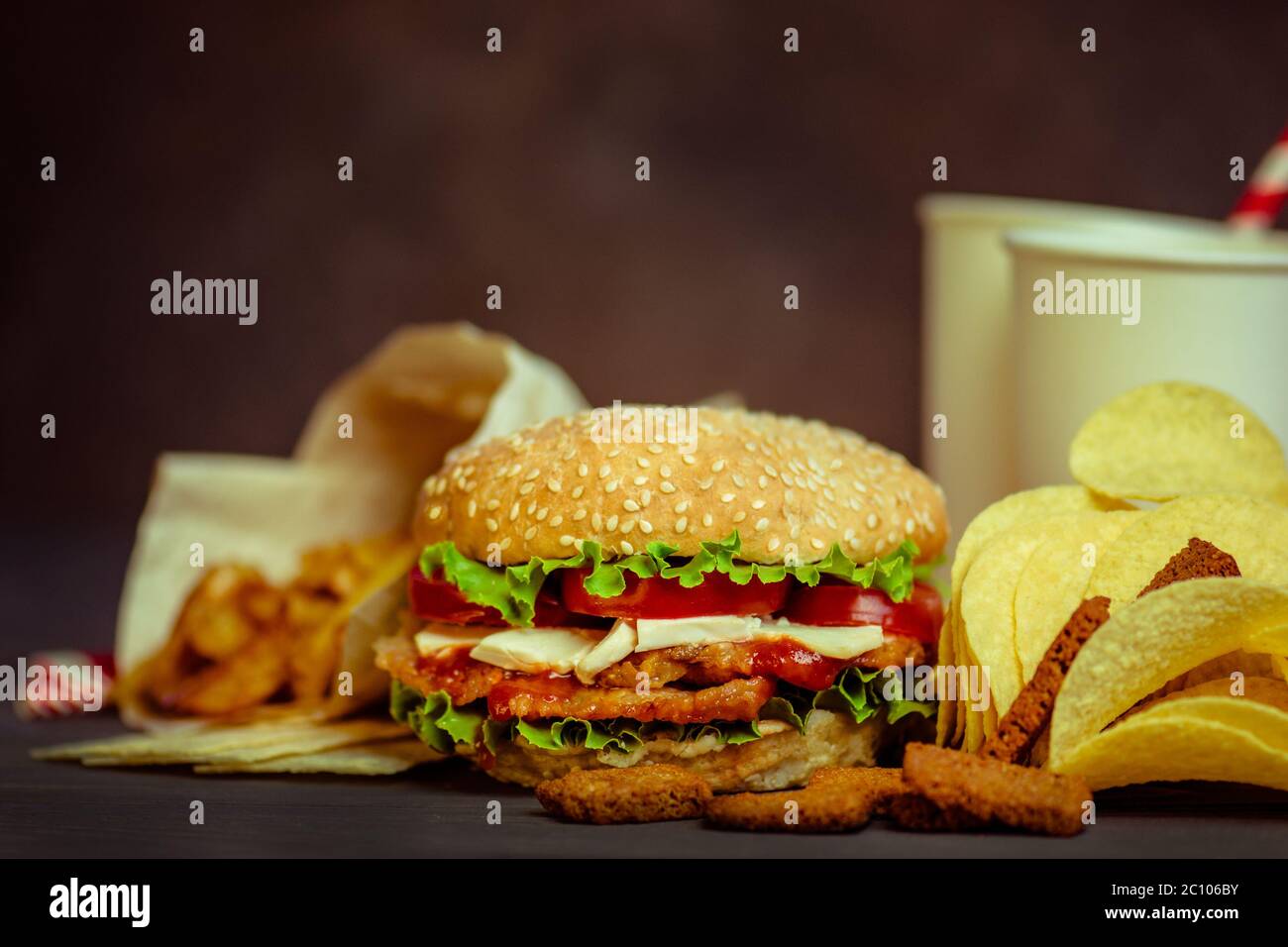 Delicious hamburger with fries, snacks and chips. Mix of snacks. Yummy ...