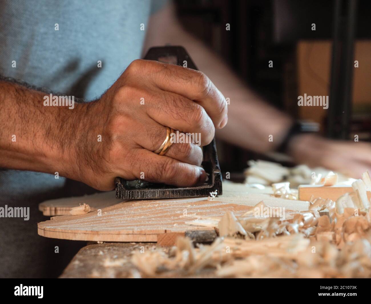 Professional luthier violinmaker artisan working on making a handmade ...