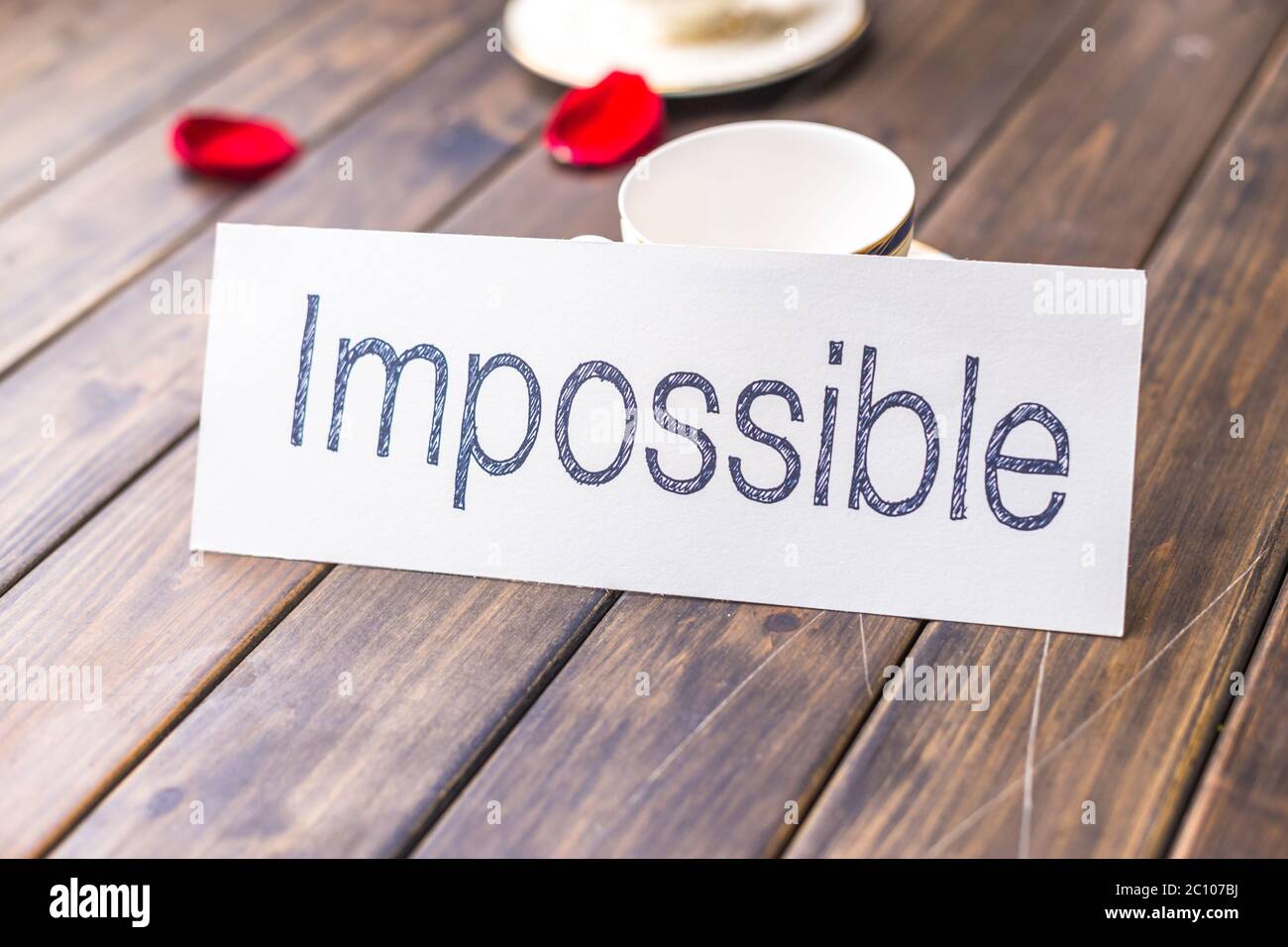 impossibel to possible on white paper Stock Photo - Alamy