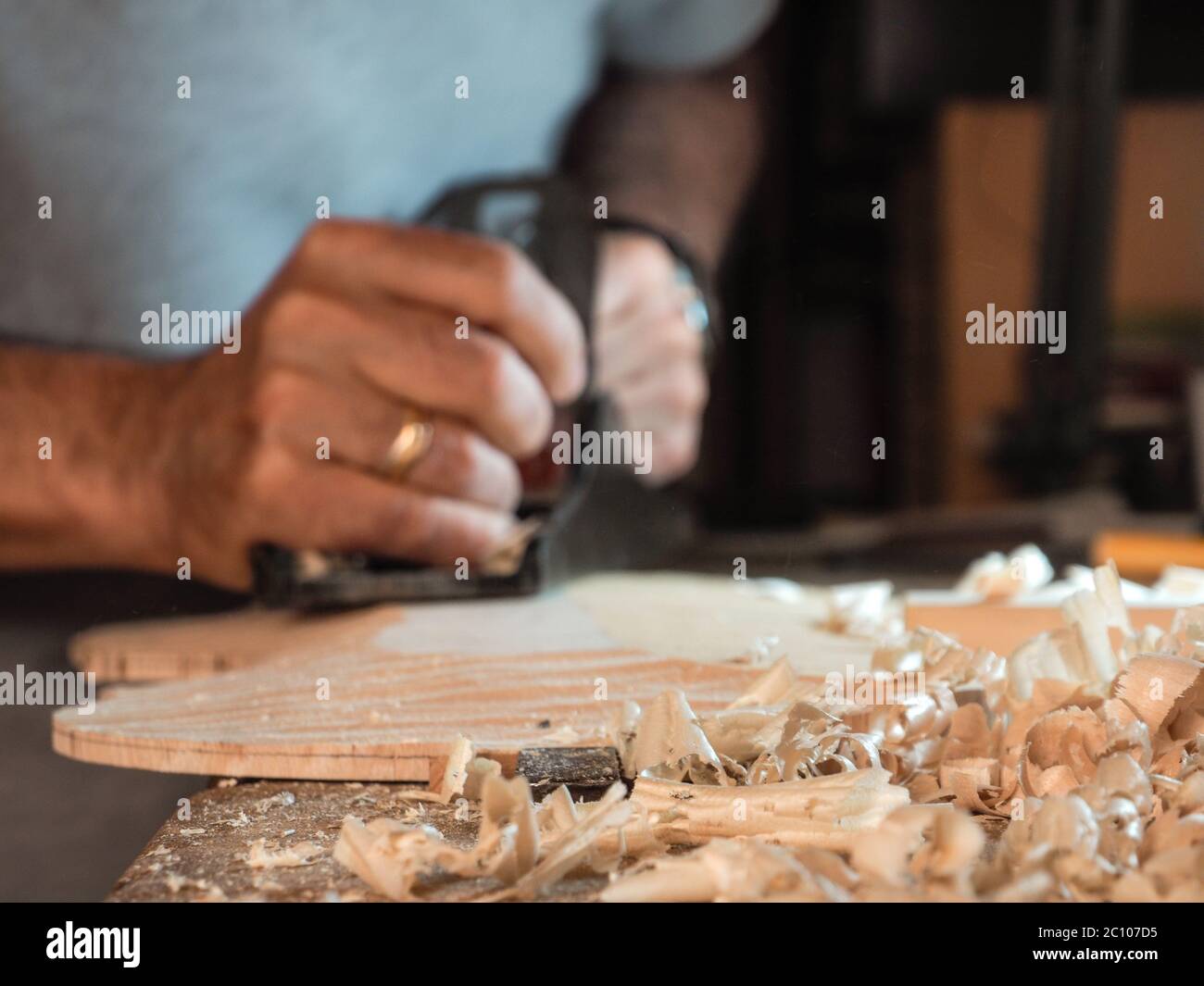 Professional luthier violinmaker artisan working on making a handmade ...