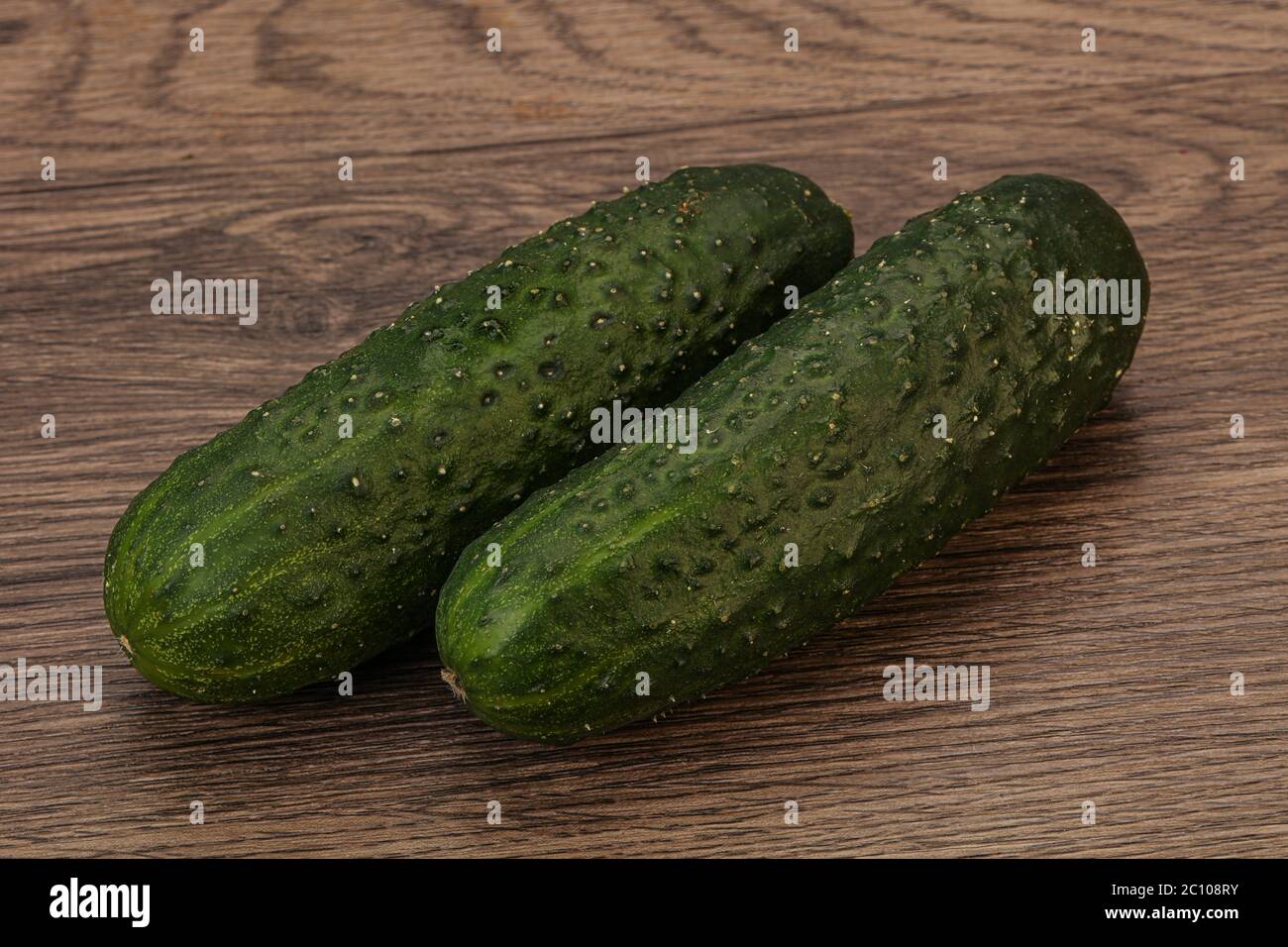 Green fresh two cucumbers over background Stock Photo - Alamy