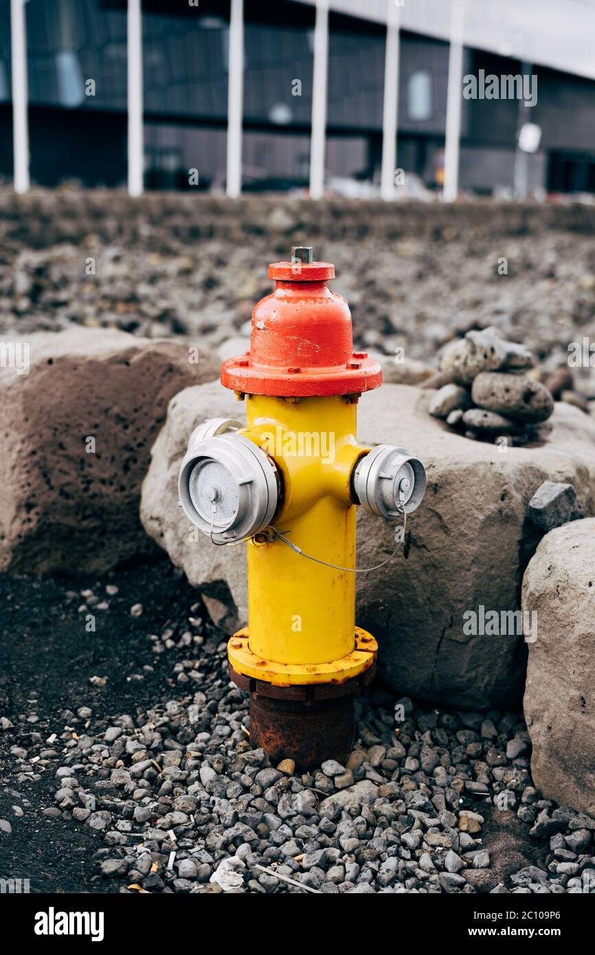 Yellow fire hydrant with red cap and silver lids Stock Photo - Alamy
