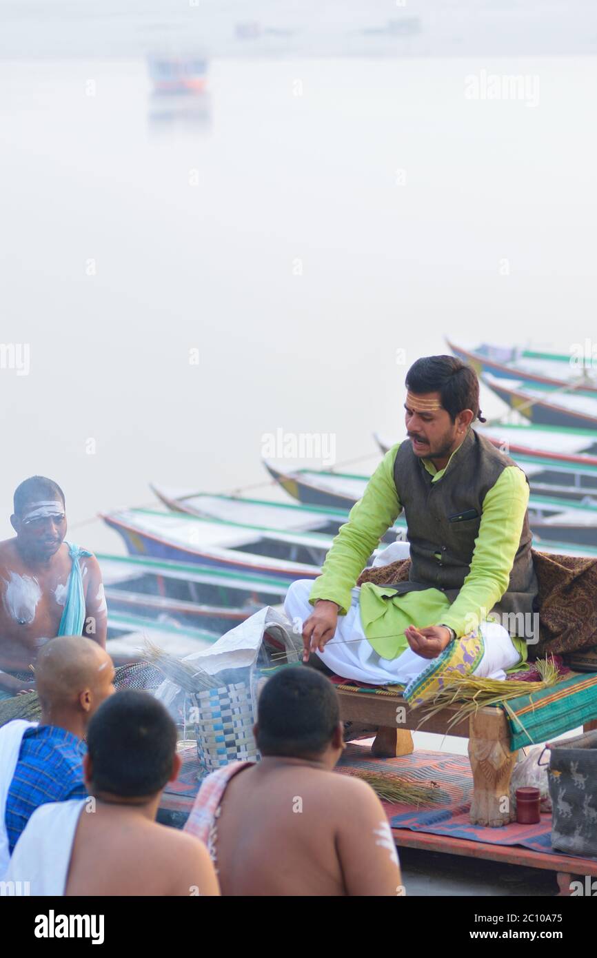 Hindu priest performing religious rituals at Ganges river bank in ...