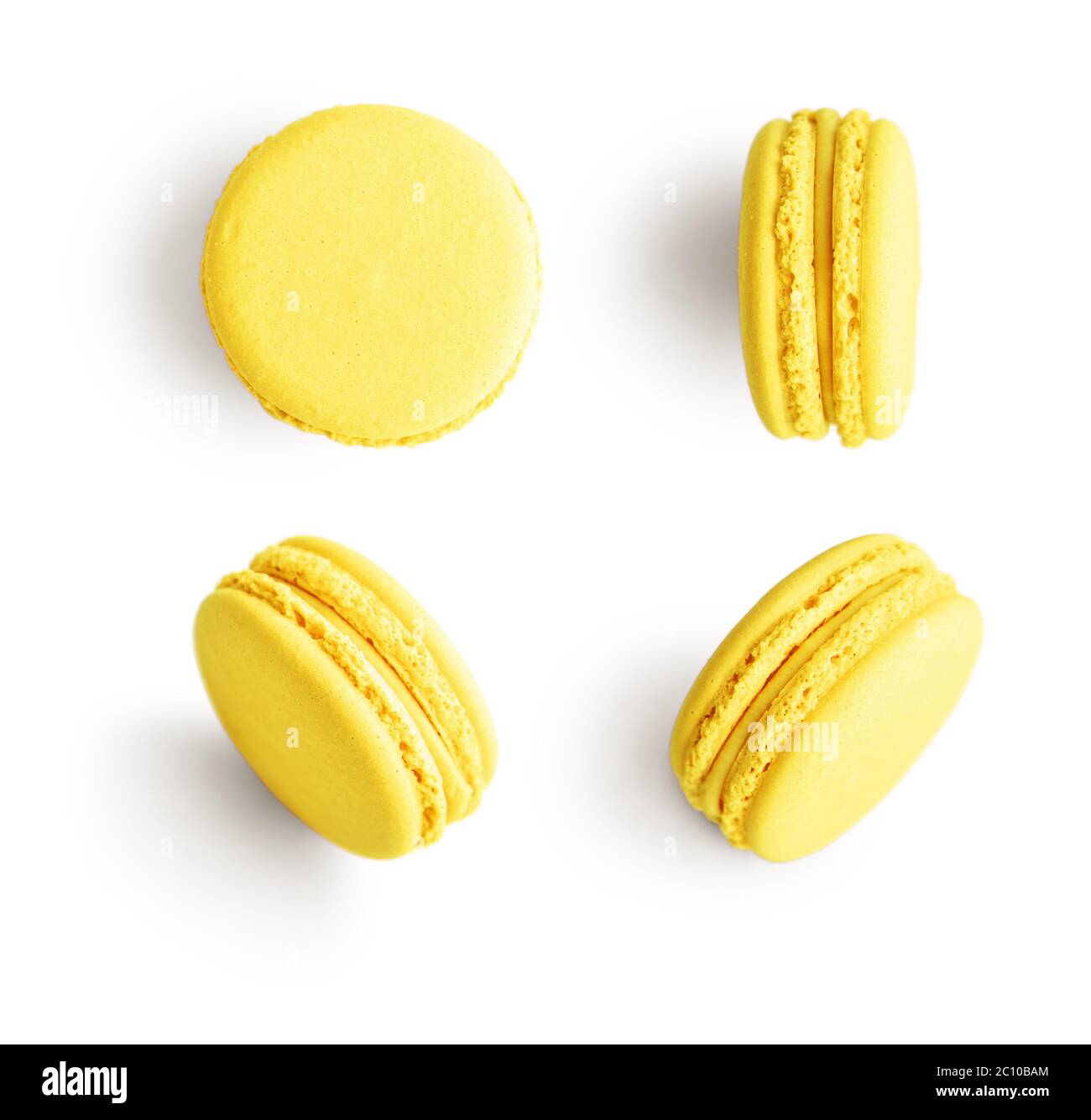 Set of yellow french macarons isolated on white background. Top view ...