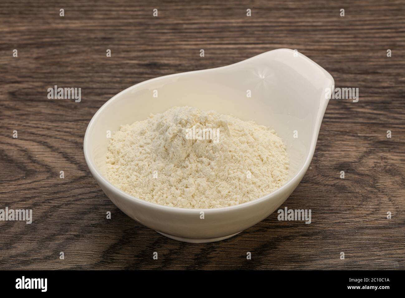 Wheat flour heap in the bowl for cooking Stock Photo - Alamy