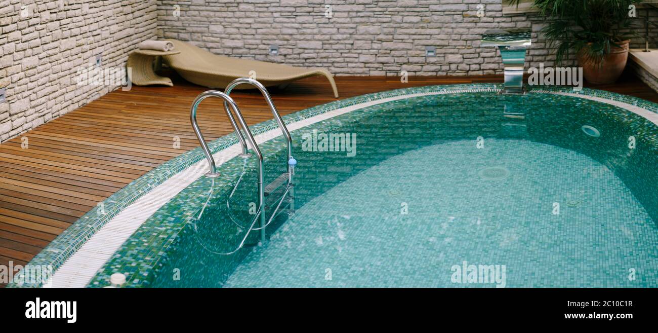 The oval turquoise swimming pool at the villa Stock Photo - Alamy