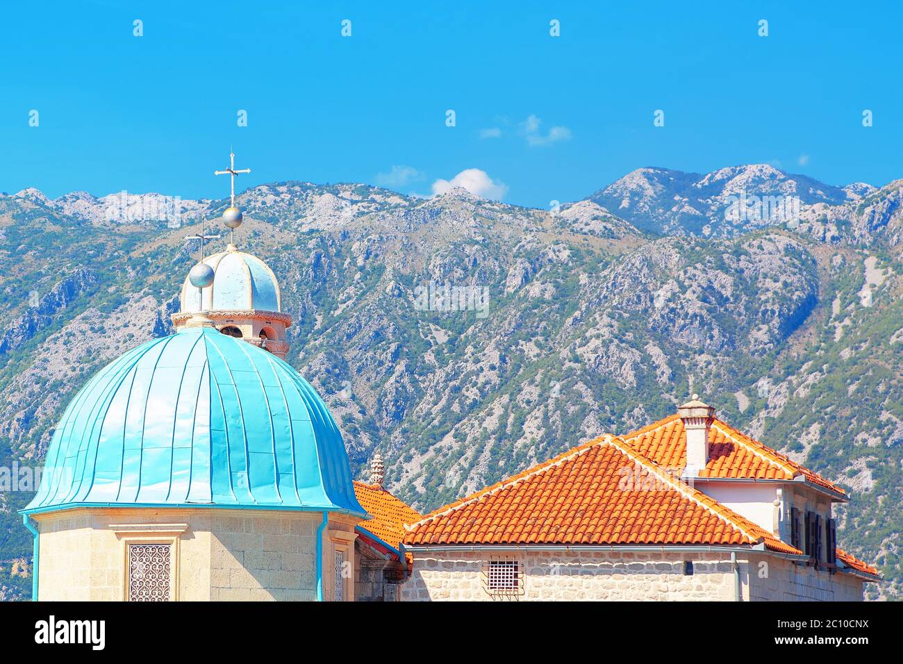 blue church cupola and tiled roof against mountain ,Our Lady of the ...