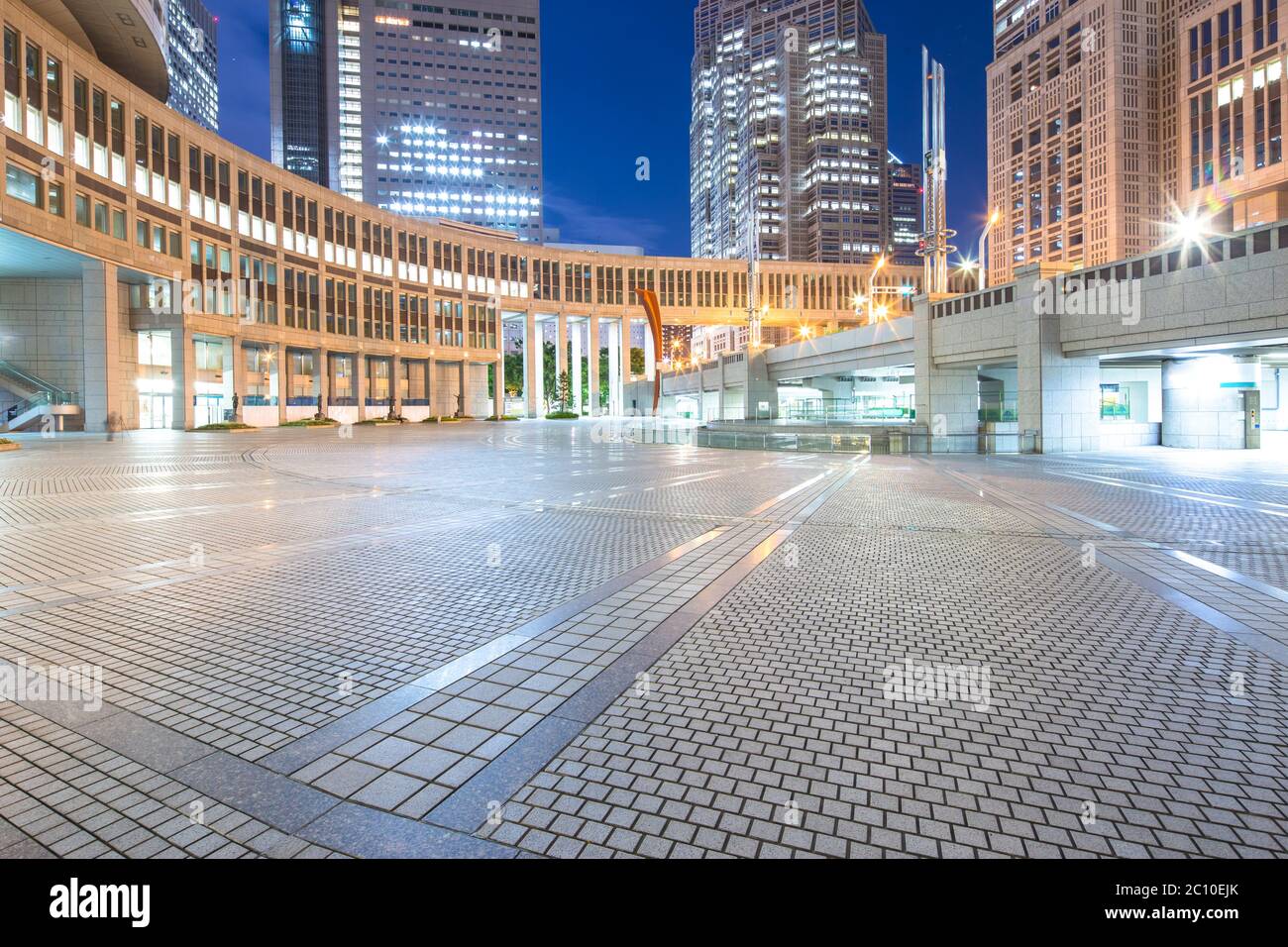 empty floor with modern office buildings in downtown of tokyo at night ...