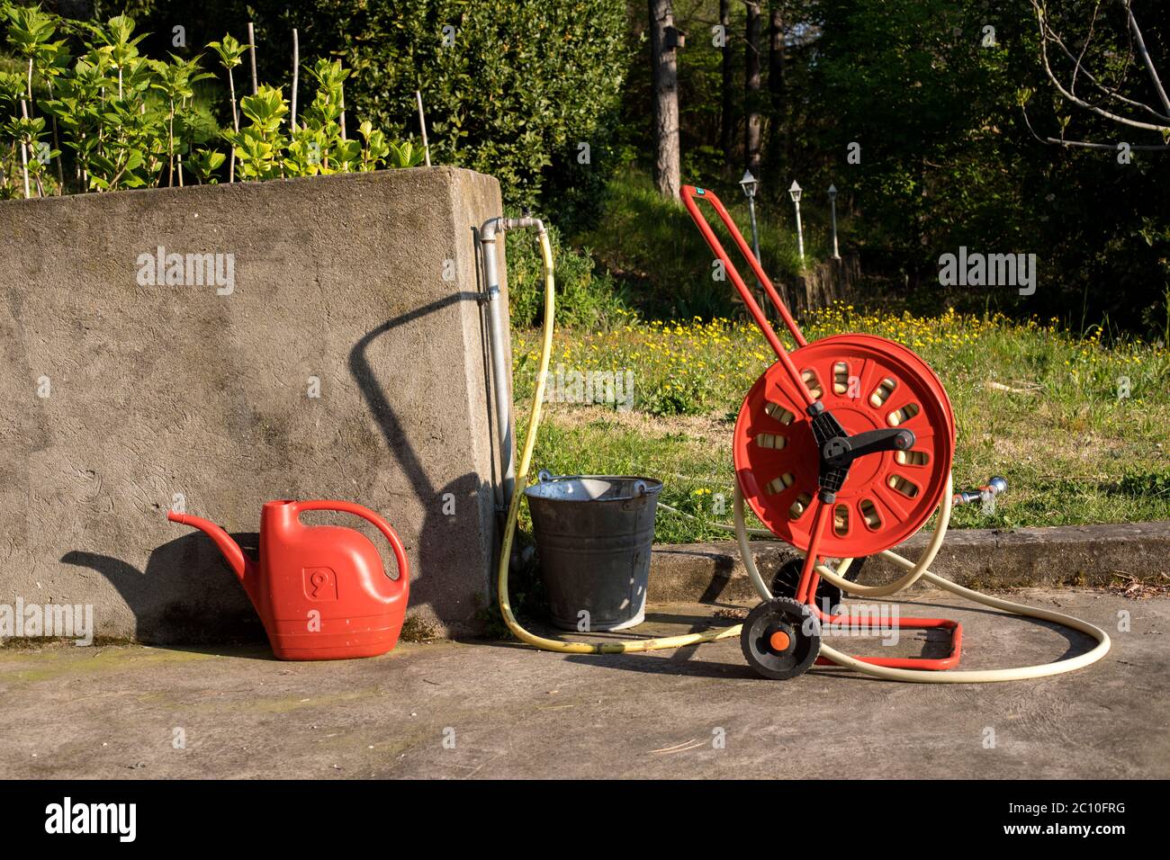 Gardening tools with watering can, garden hose and bucket Stock Photo ...