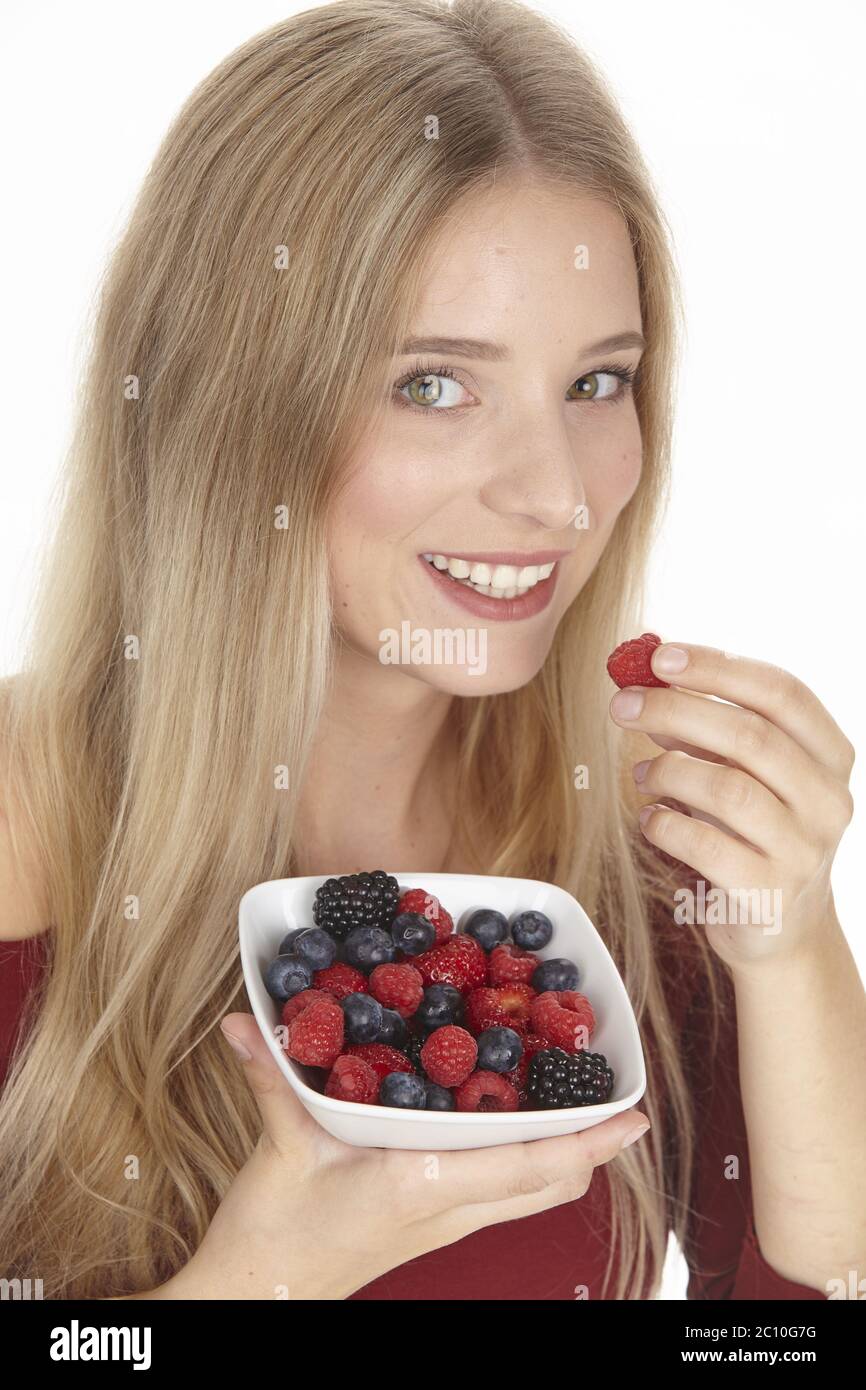 Young blonde woman eating a fruit salad (berries Stock Photo - Alamy