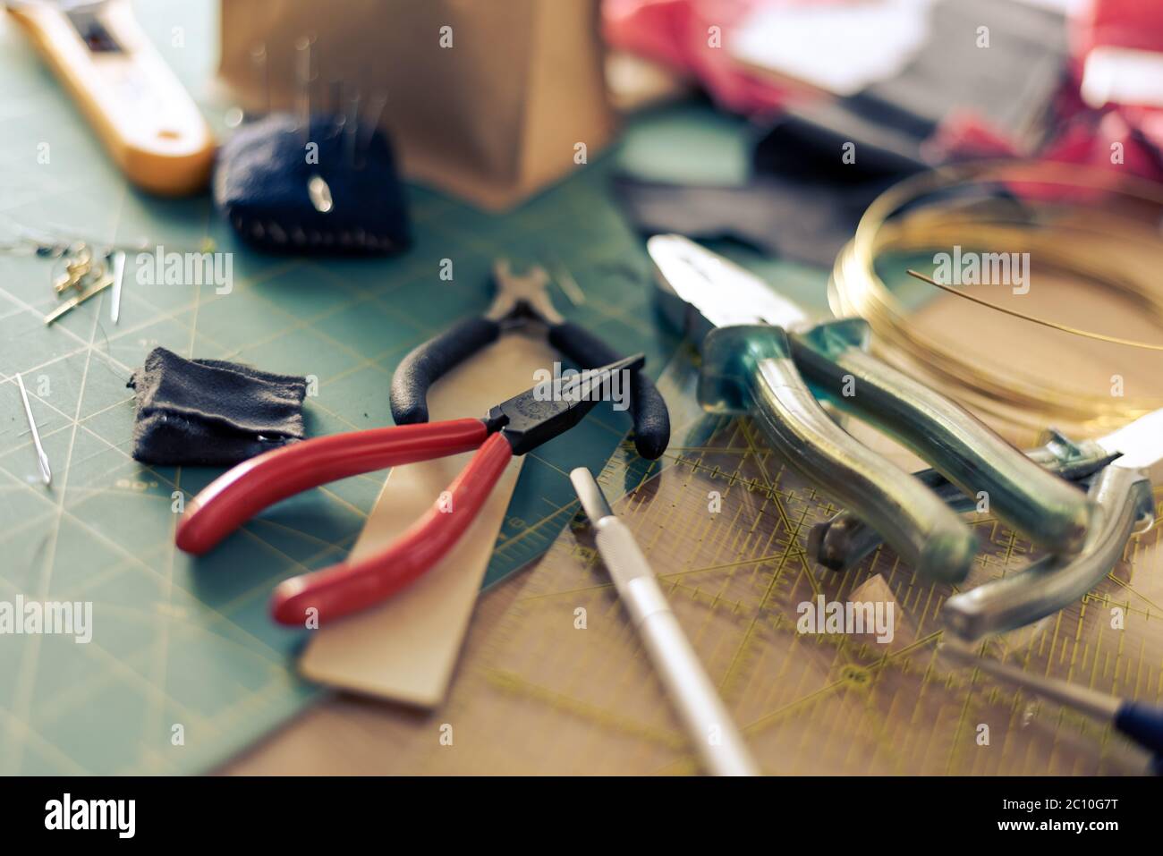 Different tongs for handiwork lying unorderly on table Stock Photo - Alamy