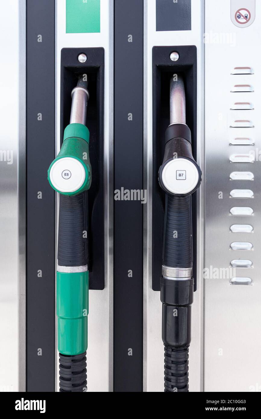 Fuel pumps. Diesel and gasoline pistol hanging on petrol pump machine ...