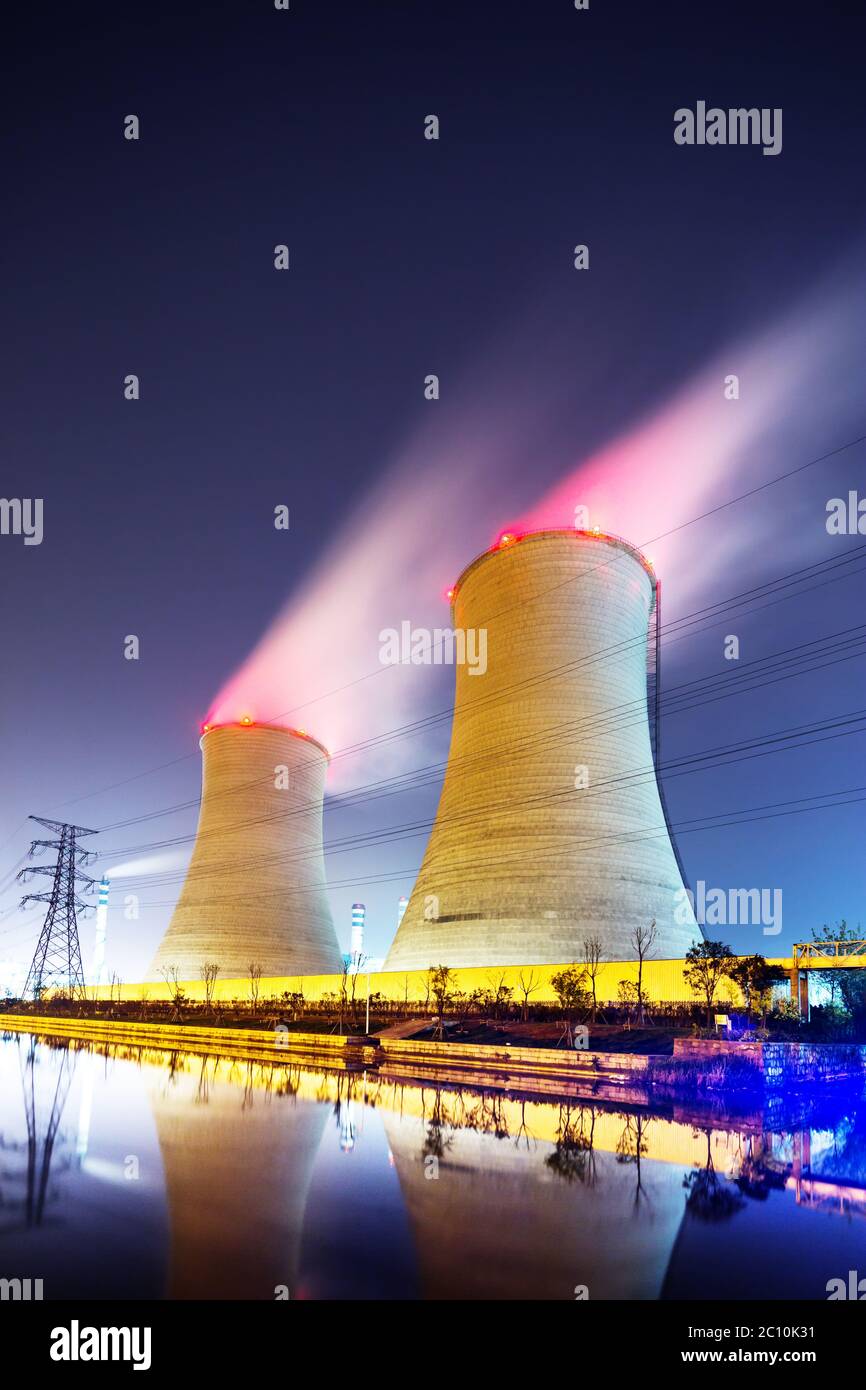 buildings of modern power station near river at twilight Stock Photo ...