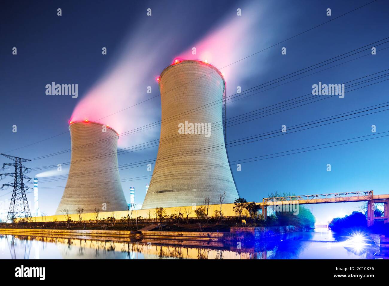 buildings of modern power station near river at twilight Stock Photo ...