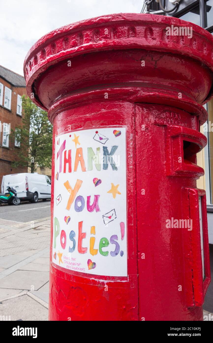 Thank you posties poster on a red post box in the UK Stock Photo - Alamy