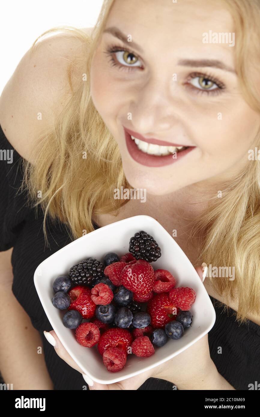 Healthy diet - she eats a bowl of fruit salad Stock Photo - Alamy
