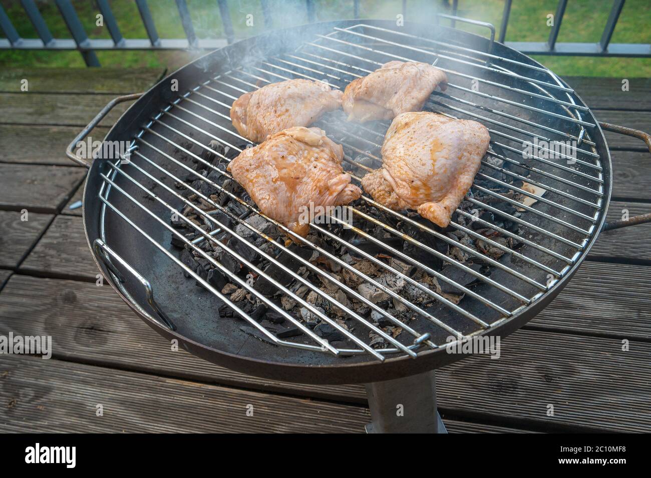 Grilled delicious chicken meat in process of cooking in outdoor at home ...