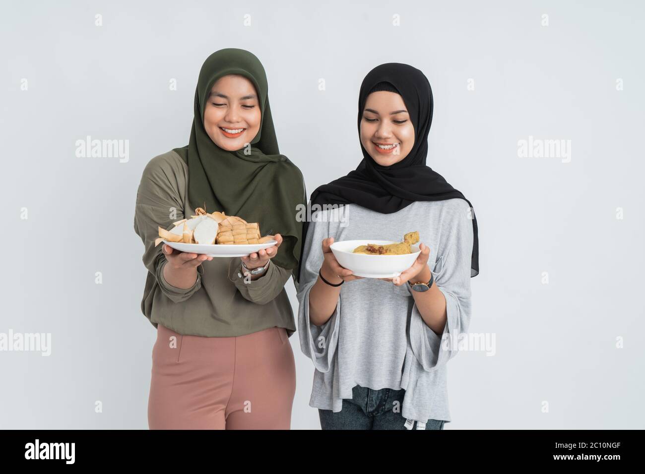 muslim woman with traditional dish for eid mubarak. ketupat opor or ...