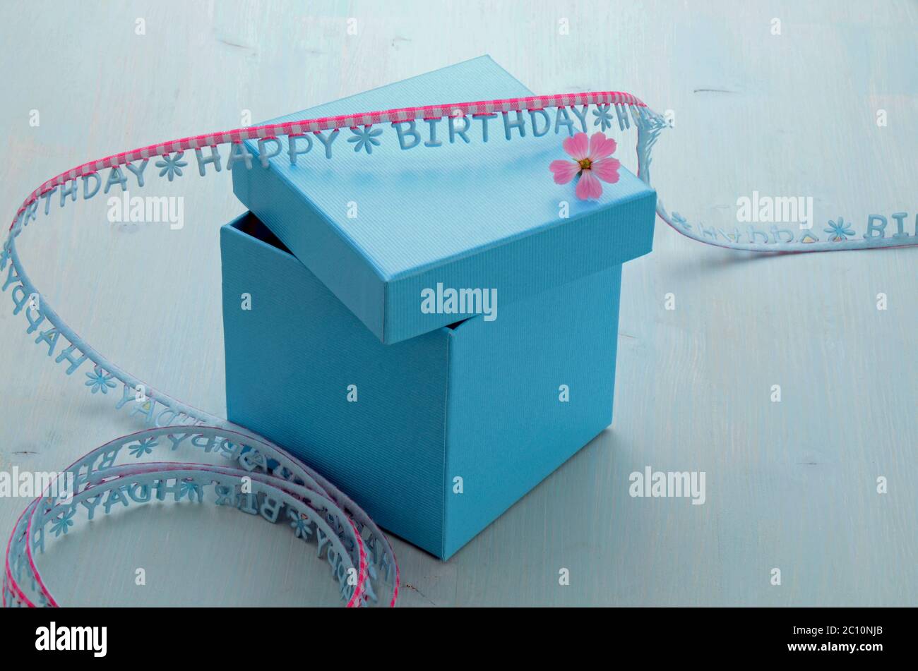 Little birthday present in a blue box Stock Photo - Alamy