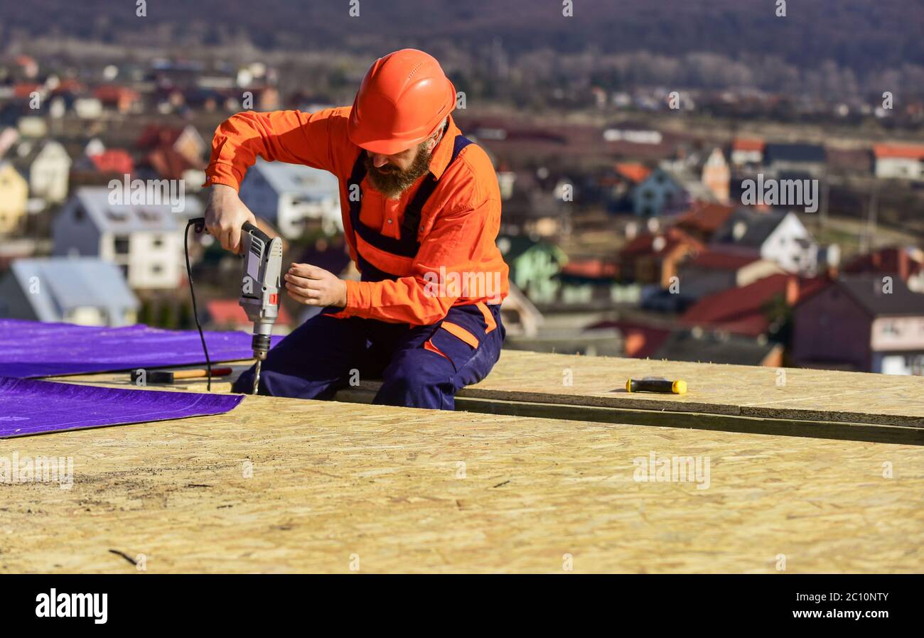 Master repair roof. Flat roof installation. Roofer constructing roof ...