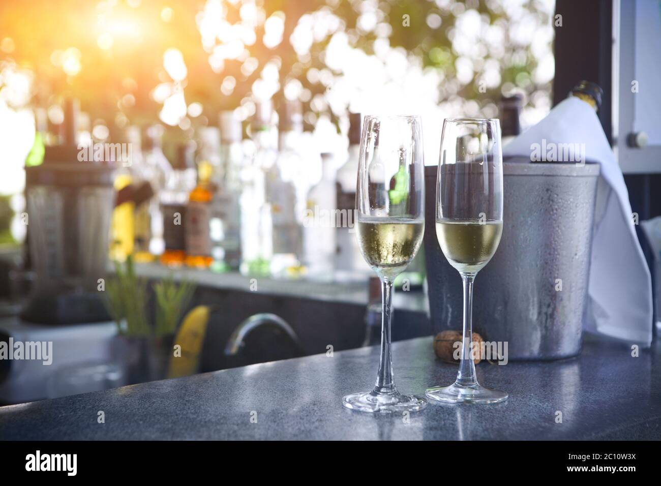 Glasses of champagne in outdoor resort bar Stock Photo - Alamy