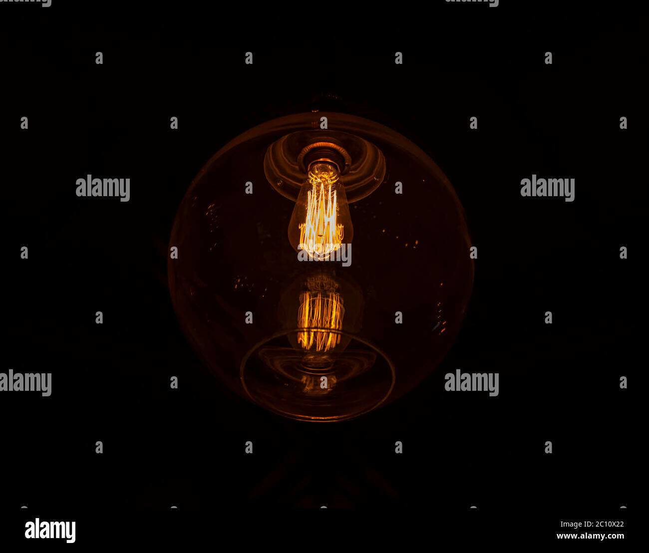 Illuminted electric glass vintage power bulb Stock Photo - Alamy