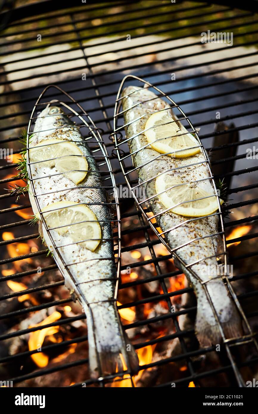 Grilling fish over camp fire hi-res stock photography and images - Alamy