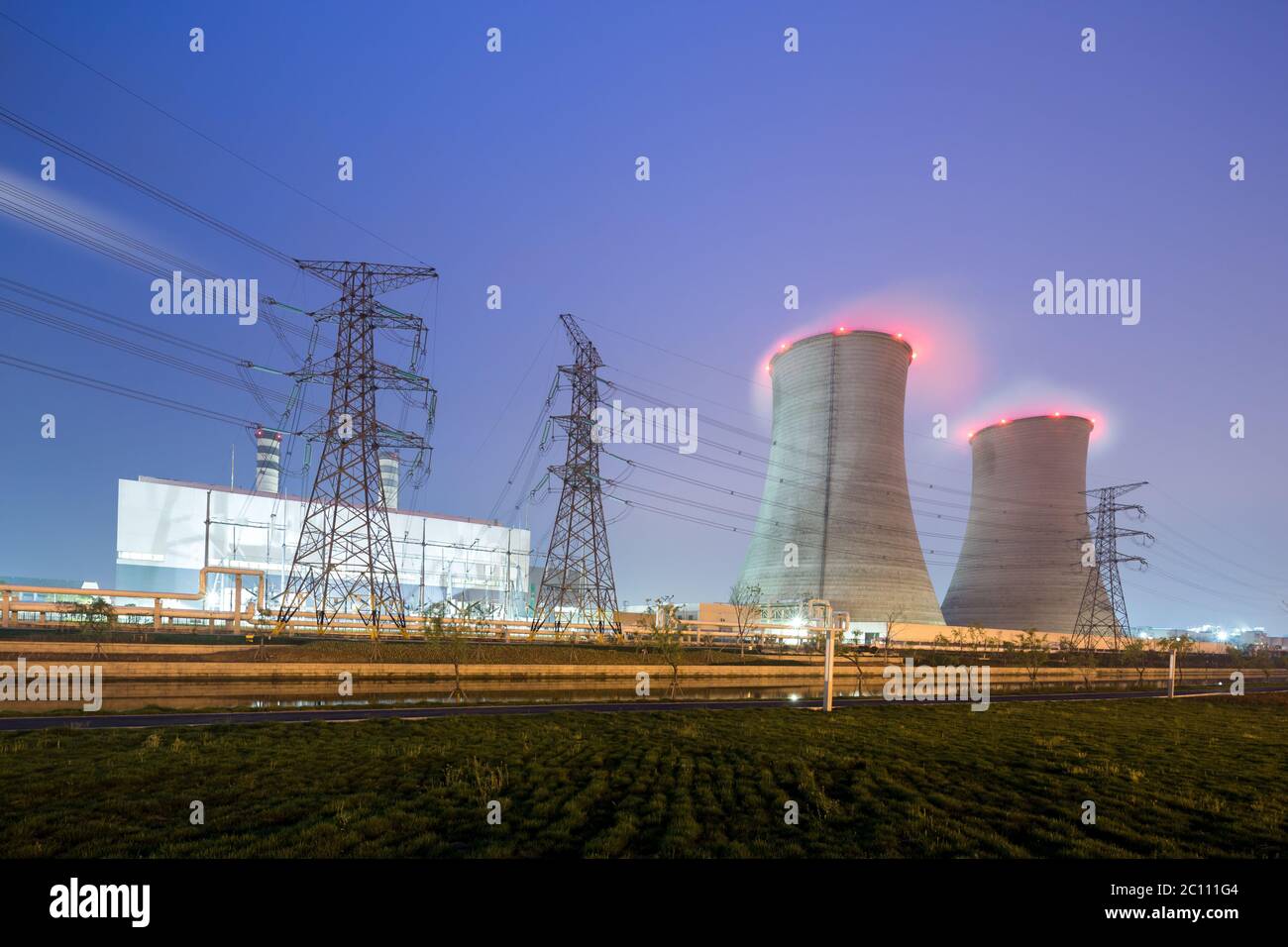 cooling towers and high pylons in modern power plant Stock Photo - Alamy
