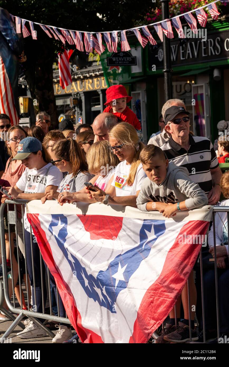 American flag and large crowd of tourists and local people waiting for ...