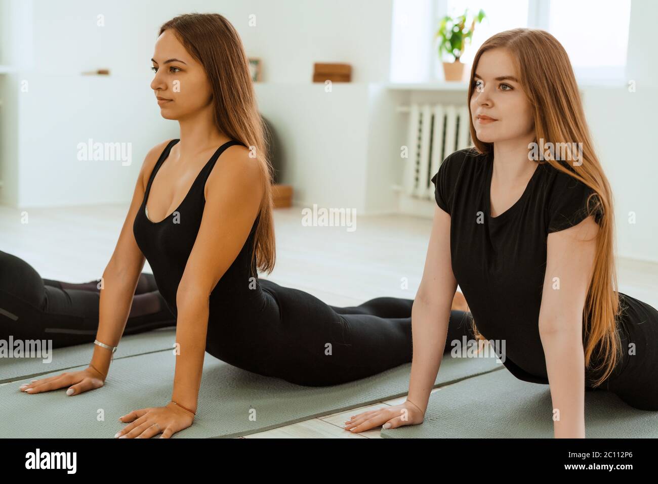 Stretching workout. A group of young girls in black uniforms are doing ...