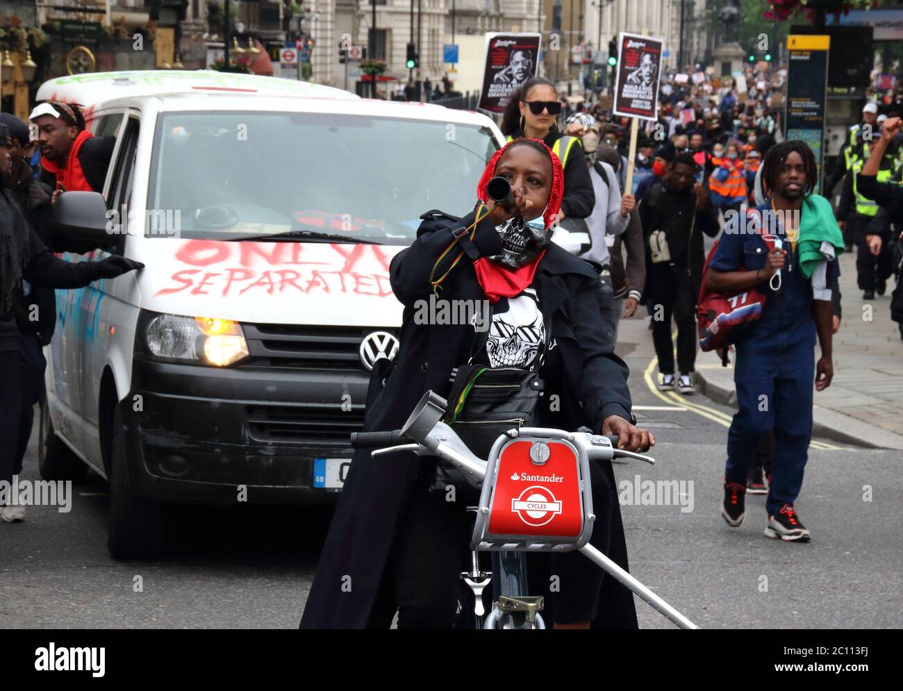 Woman blows horn as she leads the protest march along Whitehall during ...
