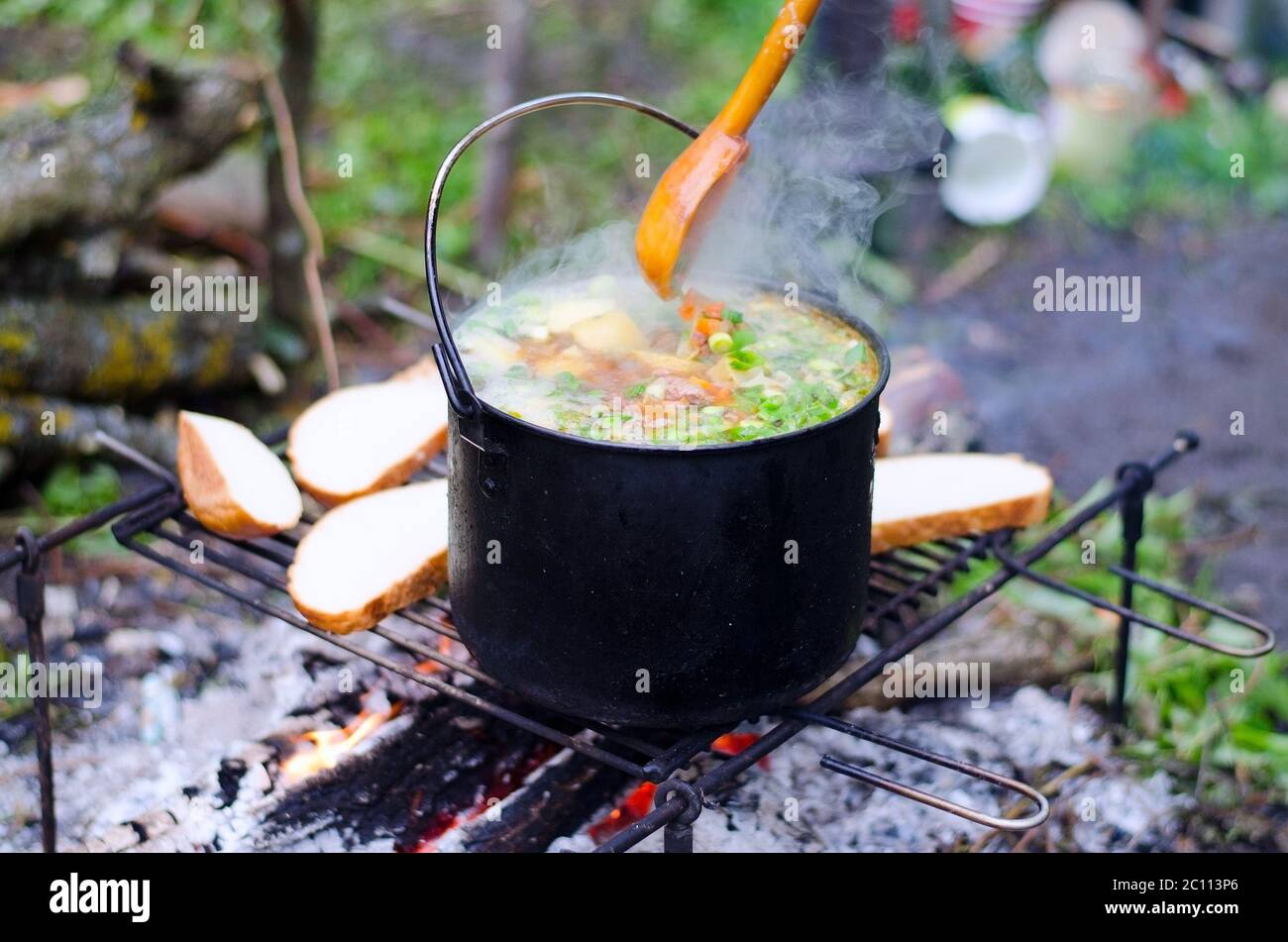 The cooking of soup on the fire Stock Photo - Alamy