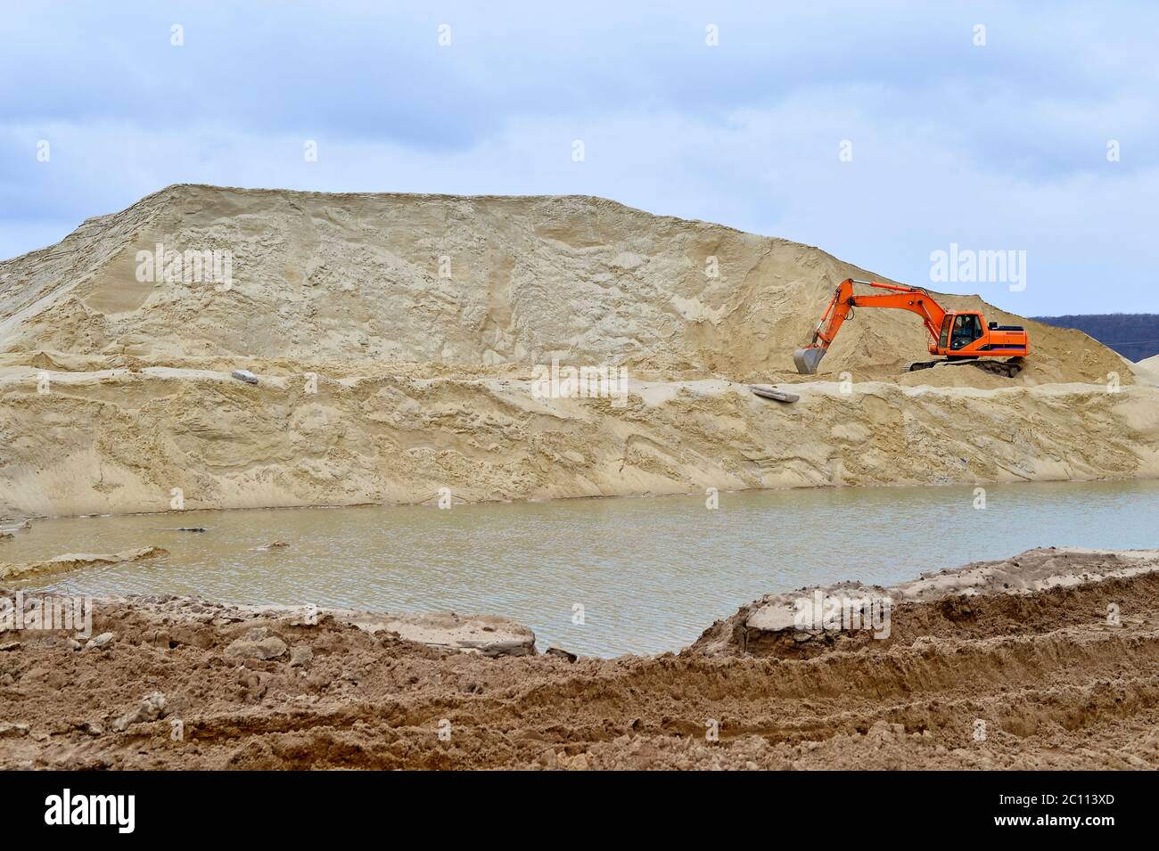 Working digger in a quarry produces sand Working digger in a quarry ...