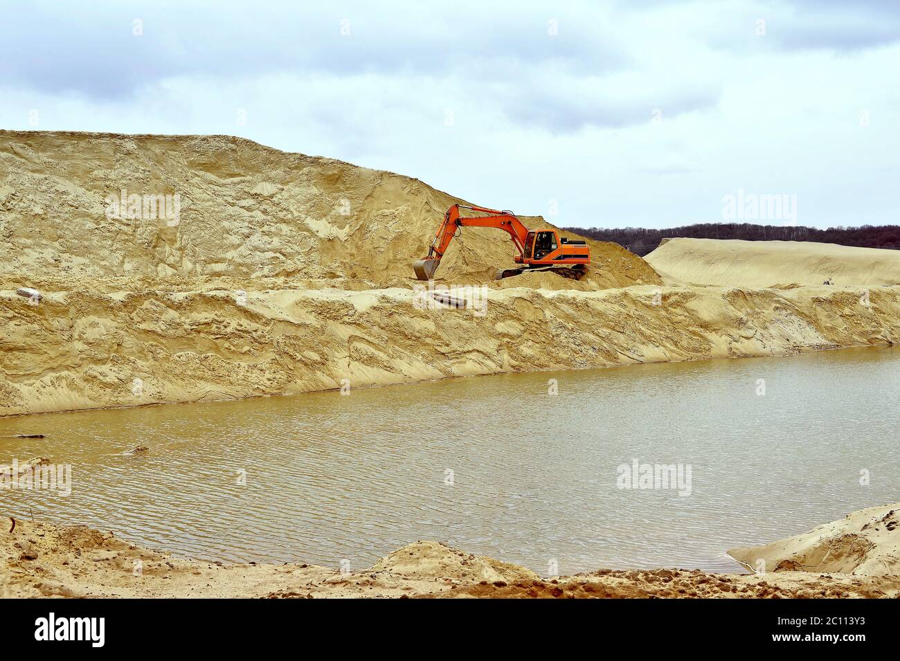 Working digger in a quarry produces sand Stock Photo - Alamy