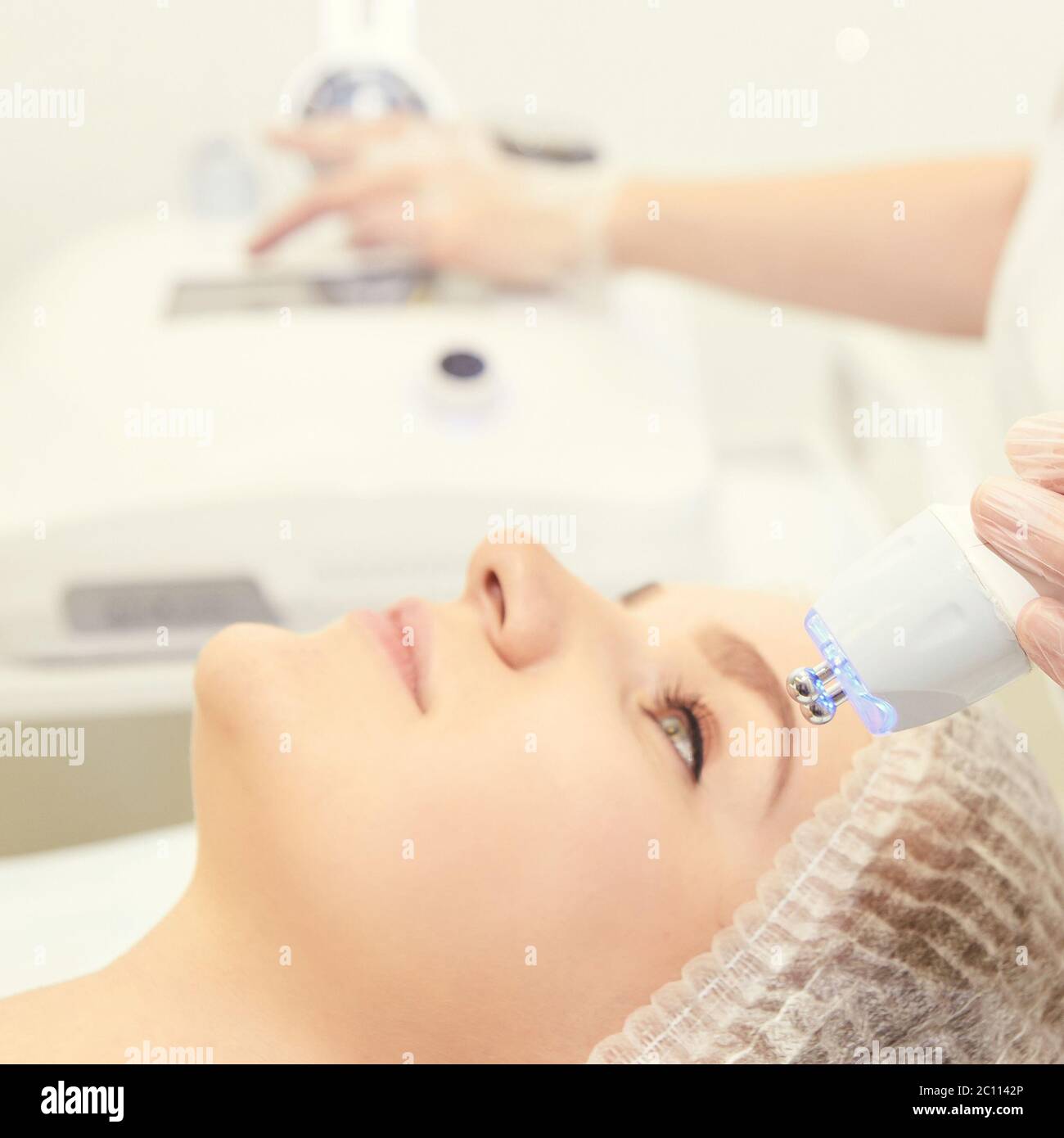 Facial micro current cosmetology procedure. Beauty technology treatment. Woman face therapy ...